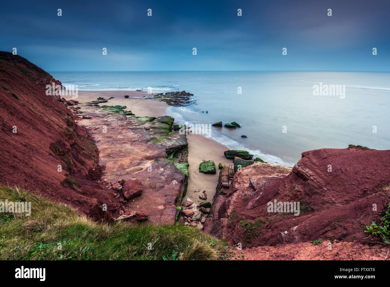 Wild beach and red rock cliffs in famous heritage site Jurassic Coast ...