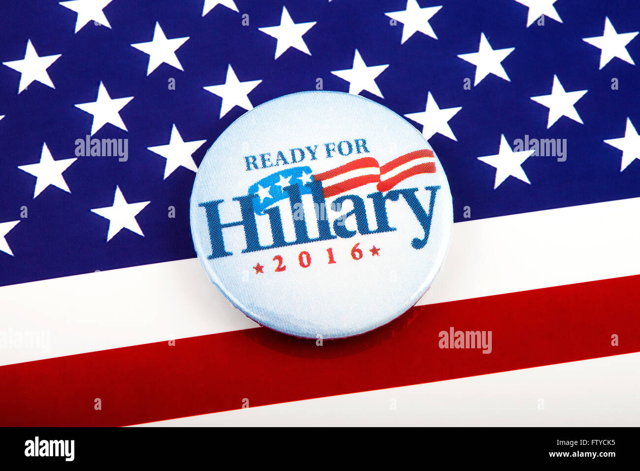 A Hillary Clinton 2016 pin badge over the US flag symbolizing her ...