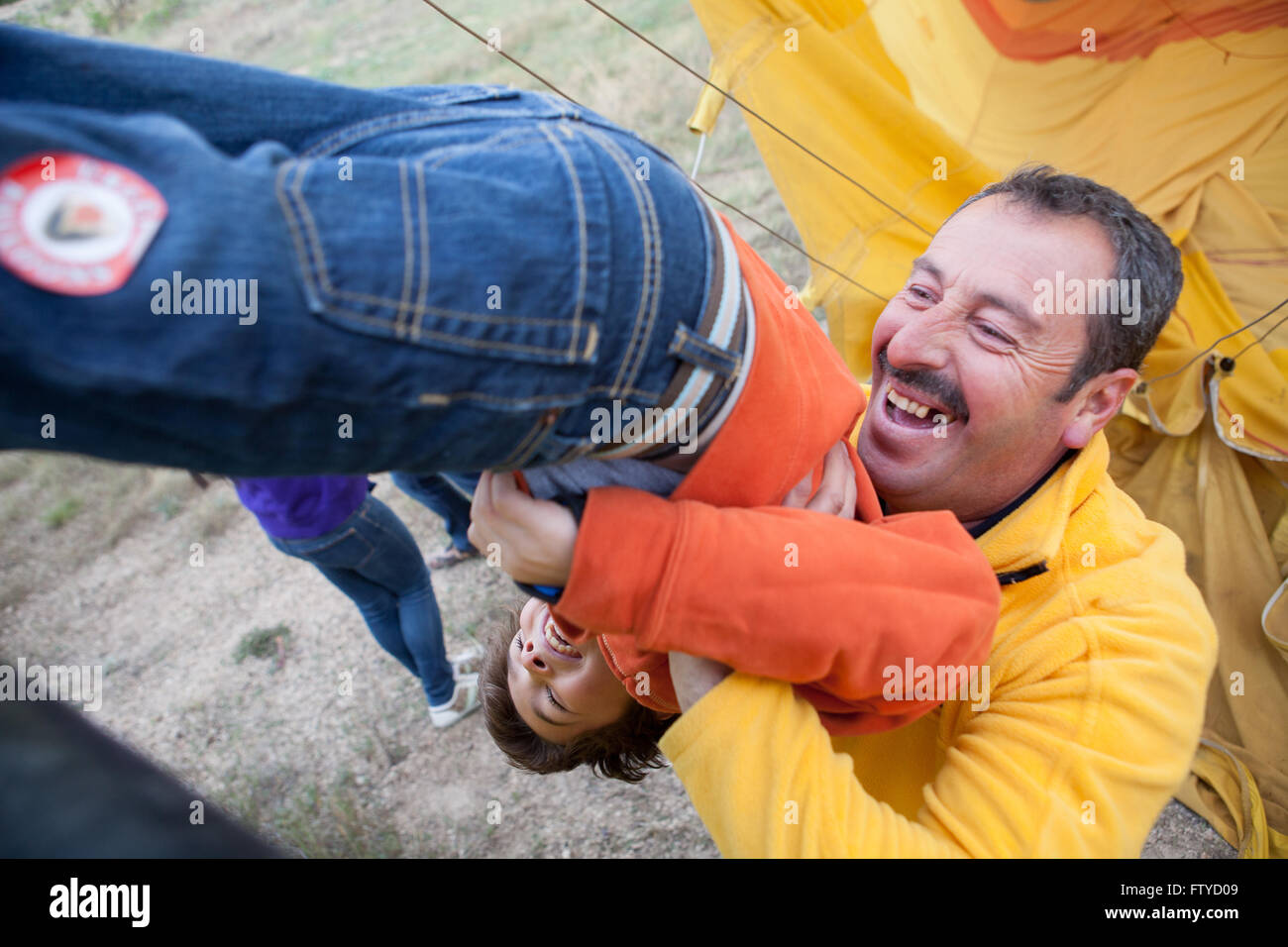 Hot air balloon pilot with boy tourist after ride Stock Photo - Alamy