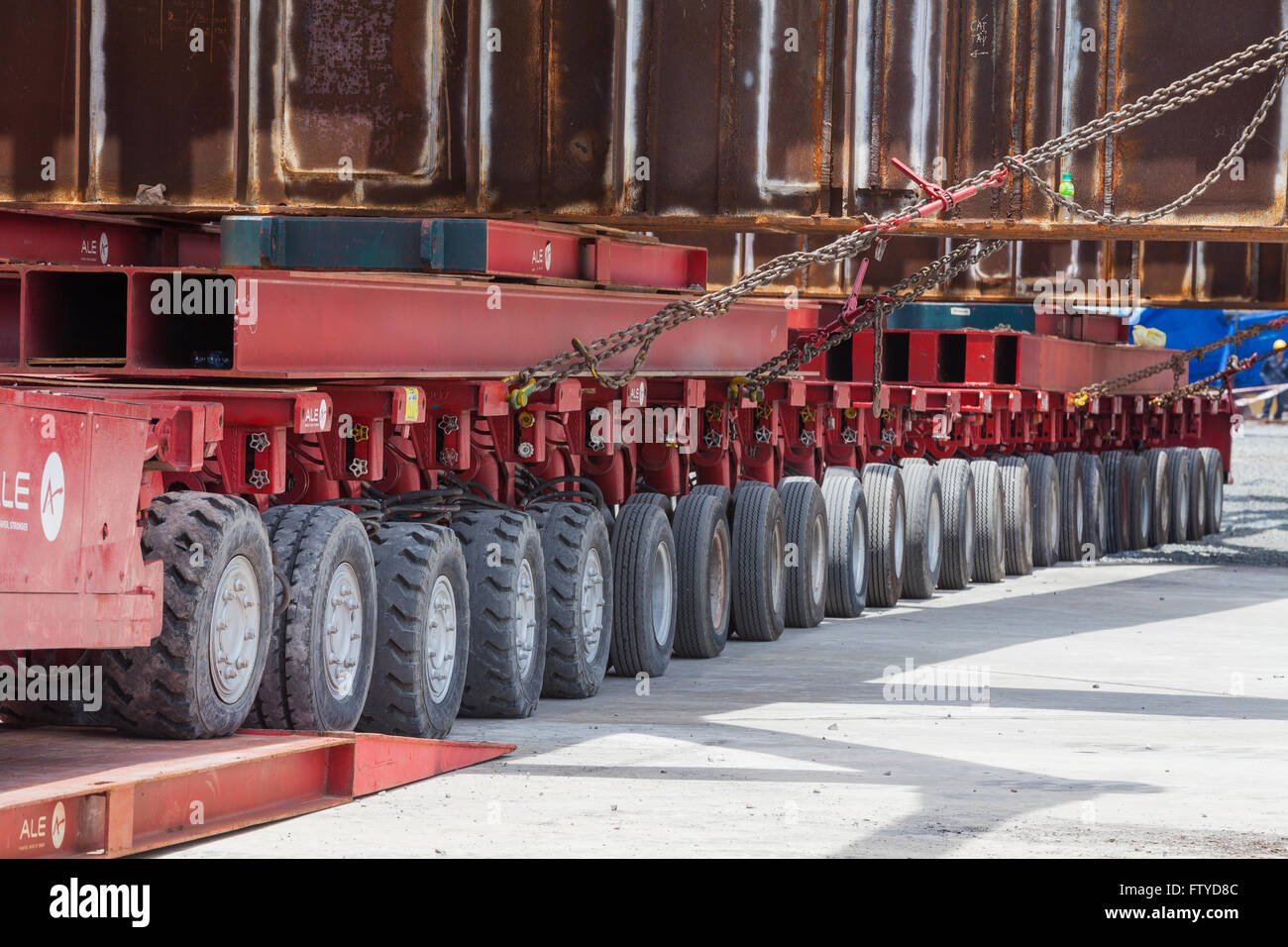 Trailer wheels when transporting an oil rig to a barge Stock Photo - Alamy