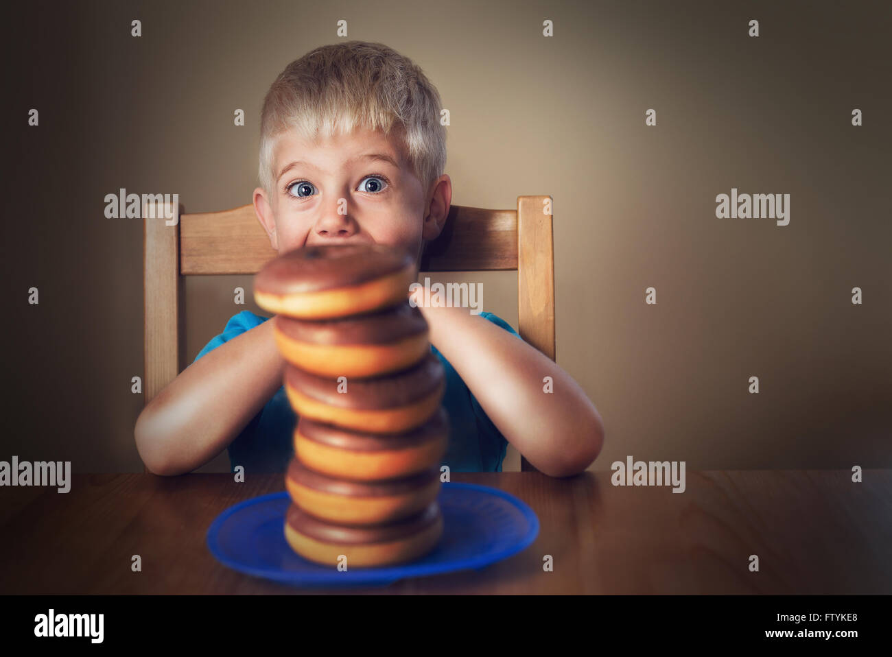 Young Child Boy Eating Donuts with Gluten and Sugar Stock Photo - Alamy