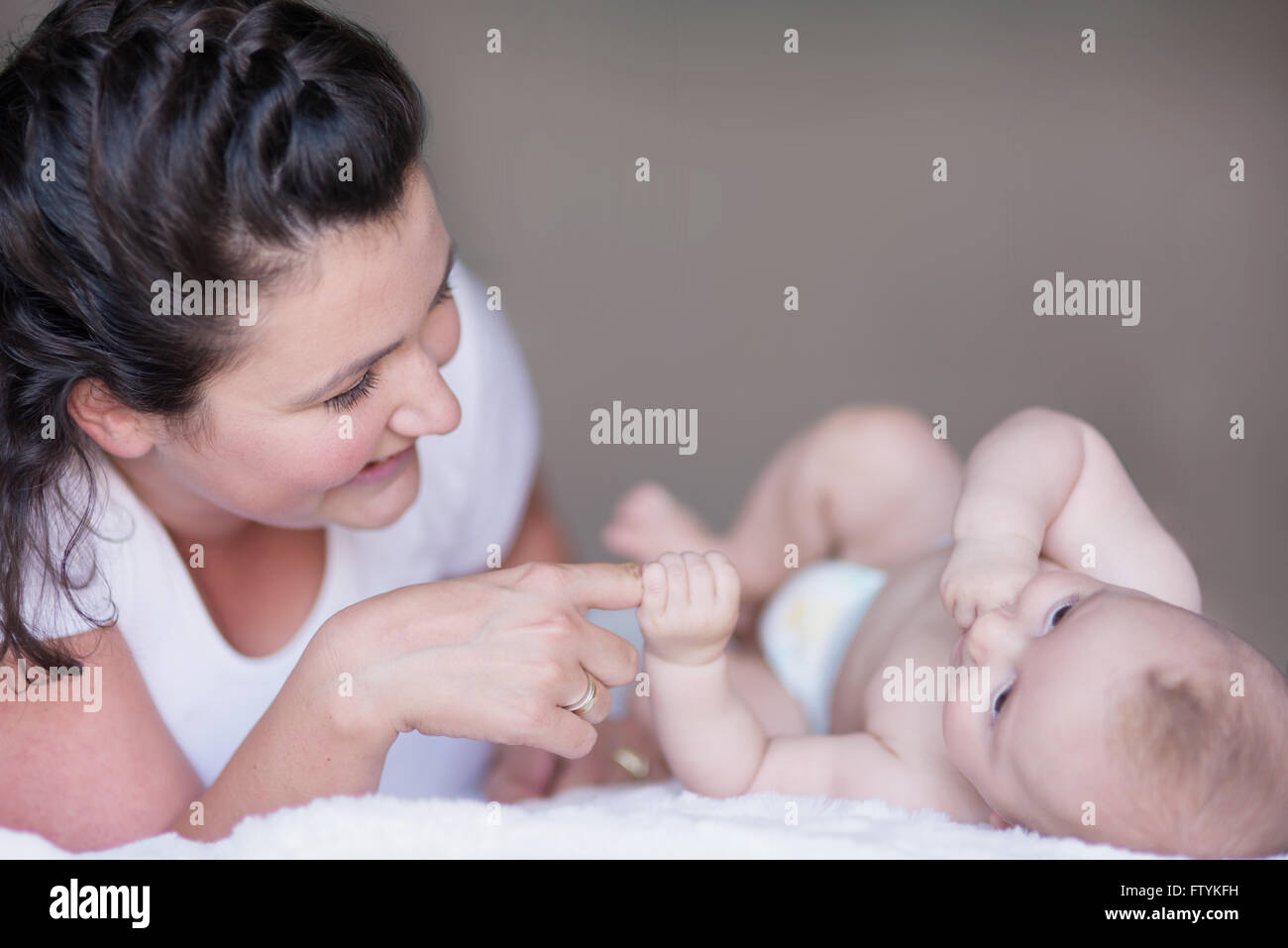 Mother interacting with baby Stock Photo - Alamy