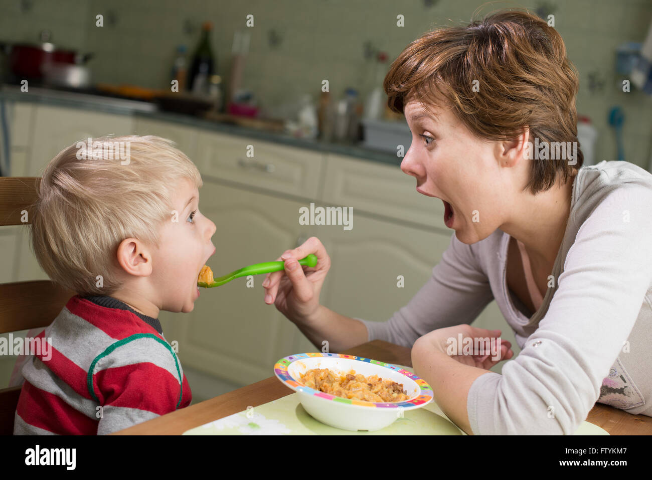 Little boy eating his dinner Stock Photo - Alamy