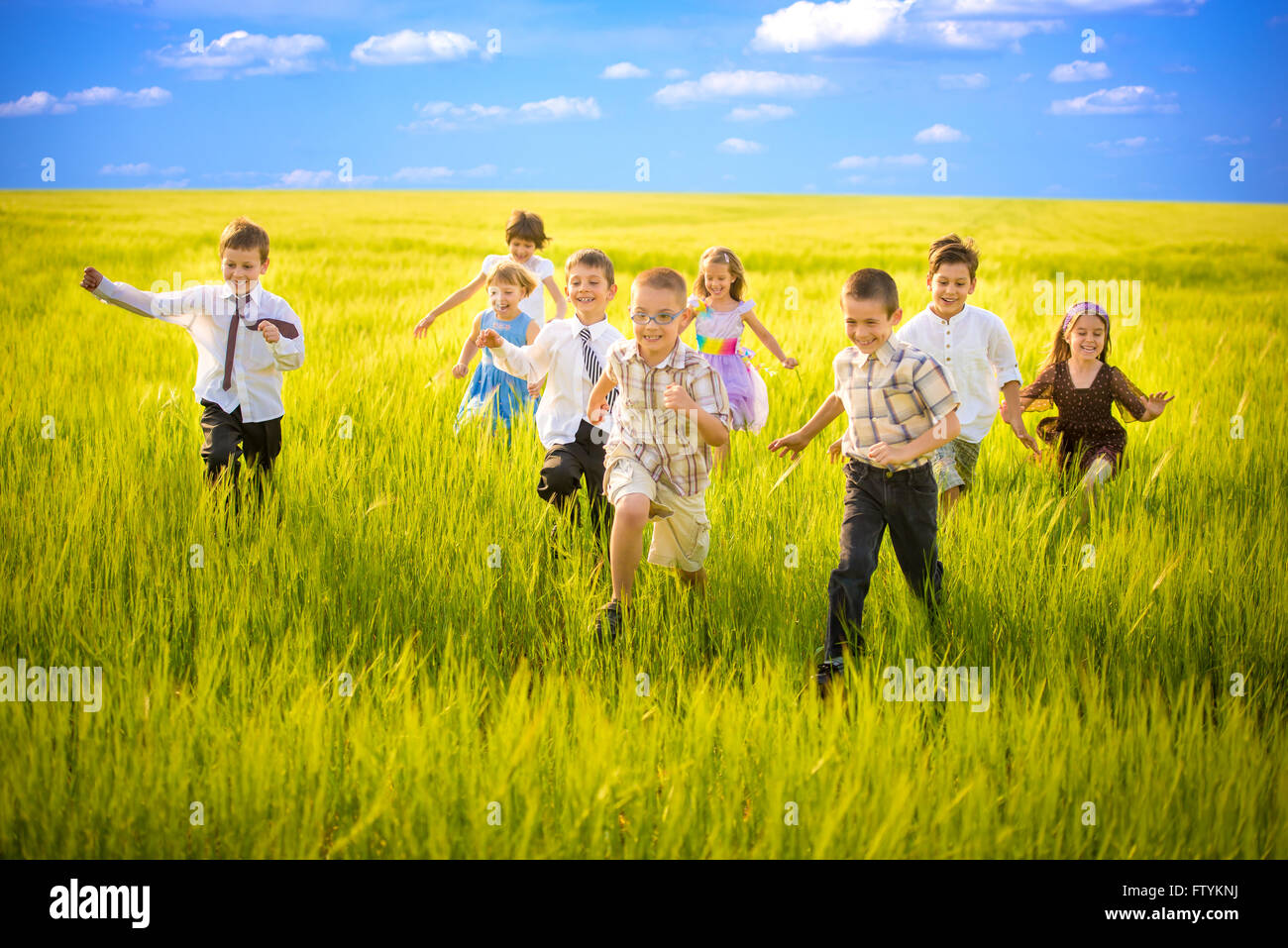 Happy Childhood Friends Running Together in Group Stock Photo - Alamy