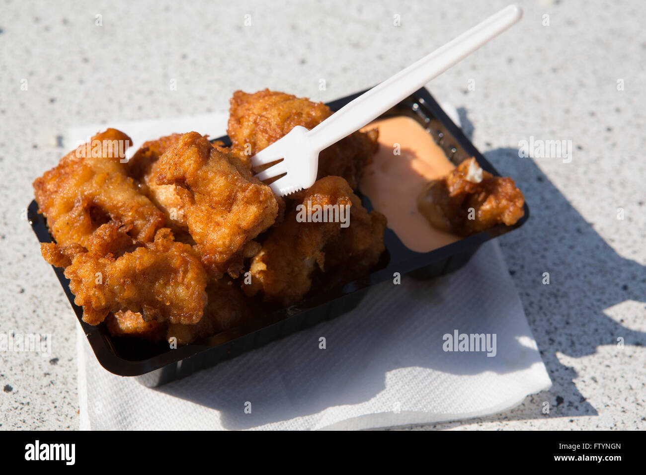 Kibbeling served with sauce and a plastic fork in the Netherlands. The ...