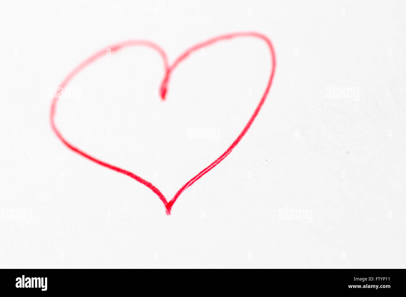 white paper with pencil and red heart on wooden background concept for ...