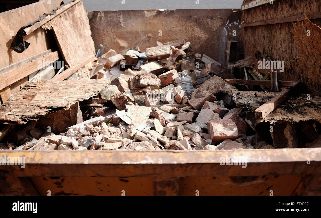 Builders Skip full of rubble DIY Stock Photo - Alamy