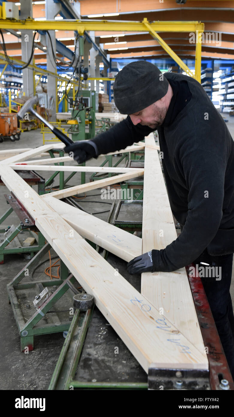 Neuruppin, Germany. 30th Mar, 2016. A carpenter works on a part of a ...