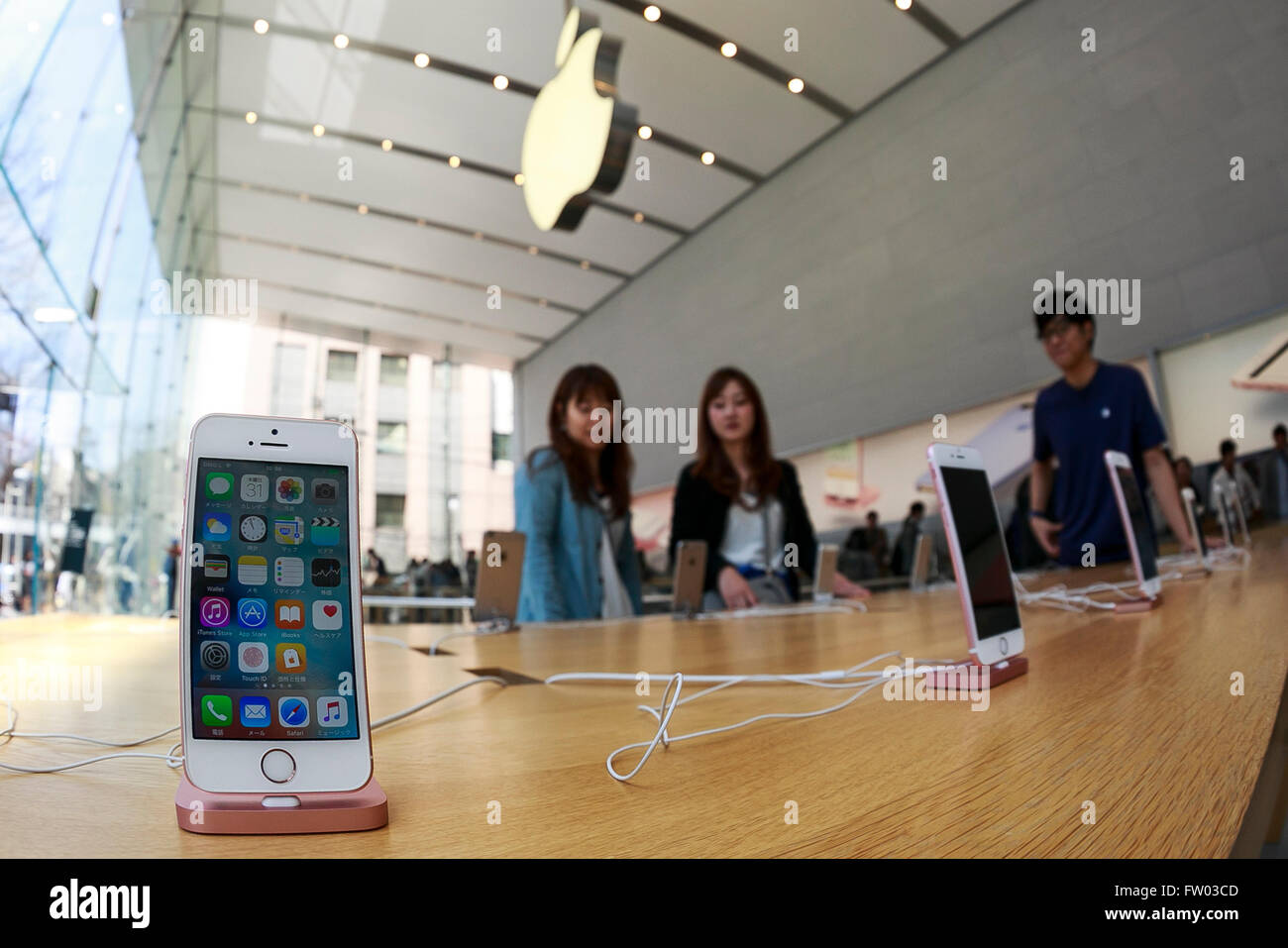 Customers look at the new iPhone SE models on display at Apple Store in ...