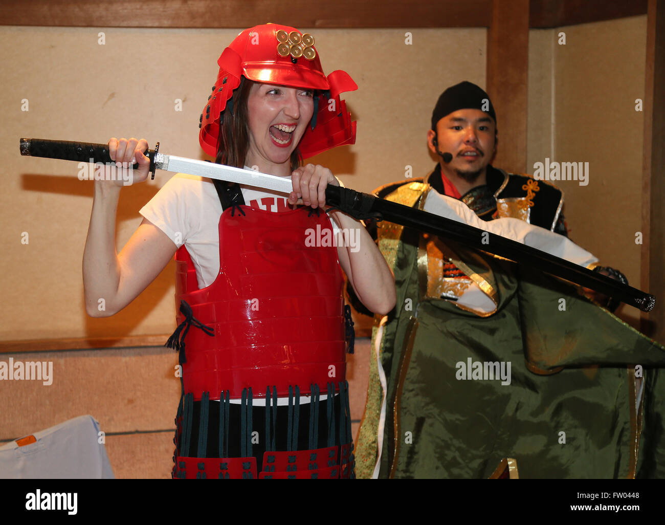 Tokyo, Japan. 29th Mar, 2016. A foreign tourist tries to wear samurai ...