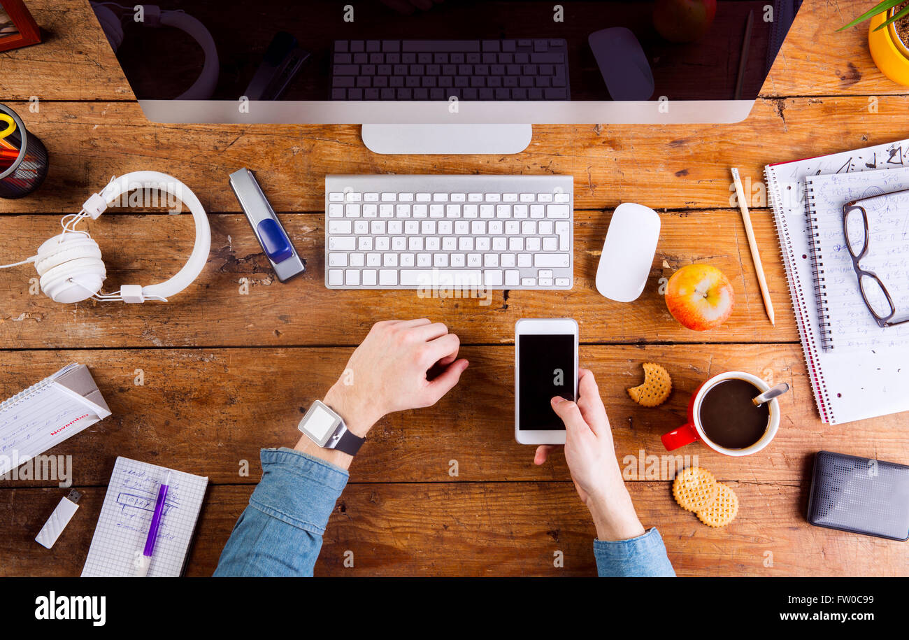 Business person working at office desk wearing smart watch Stock Photo ...