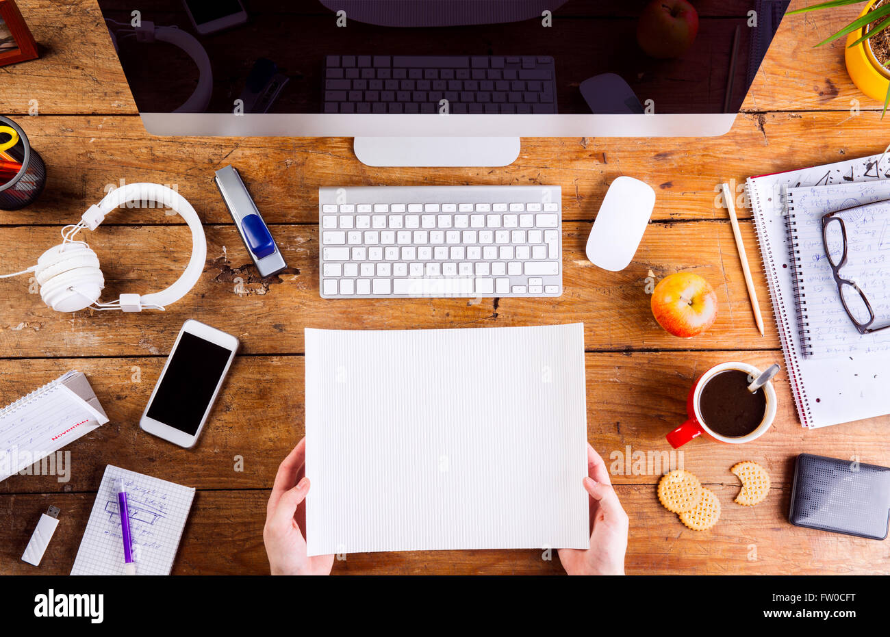 Business person working at office desk holding paper sheet Stock Photo ...