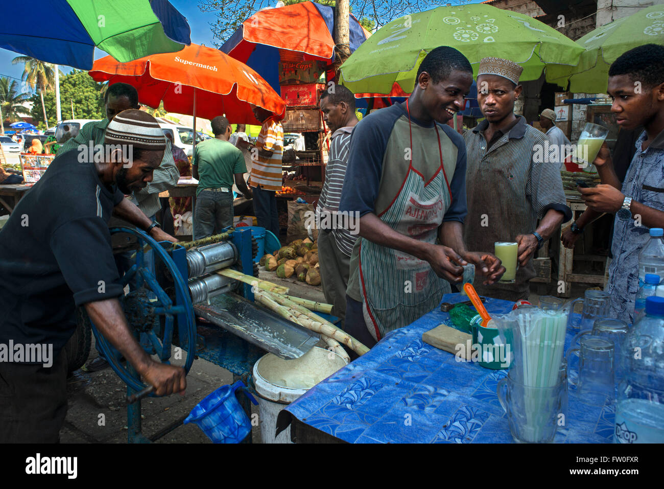 Local people elaborating sugar cane juice naturally in the Stone Town ...