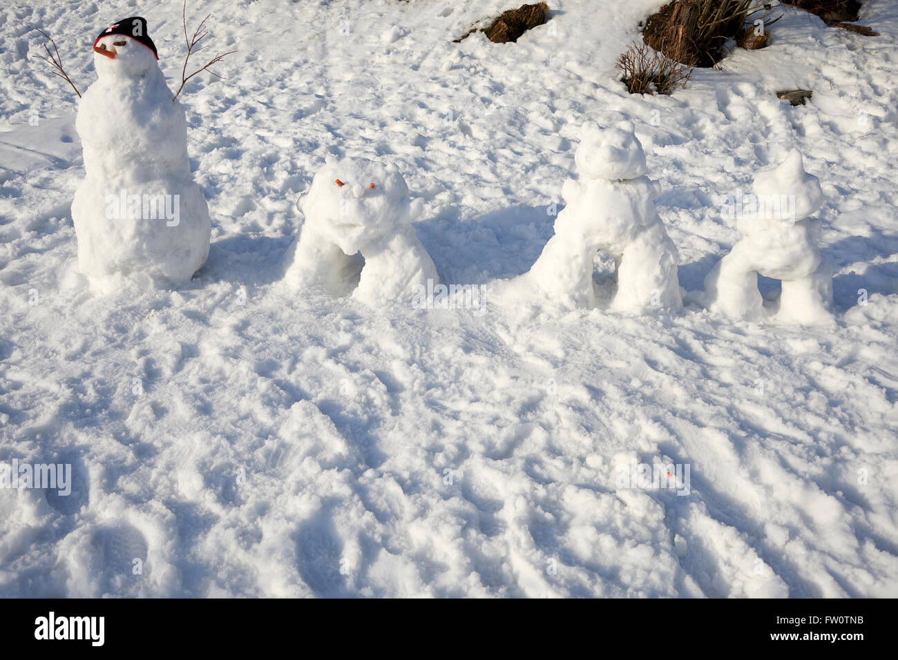 Snowman creature standing in winter landscape, made by children. A ...