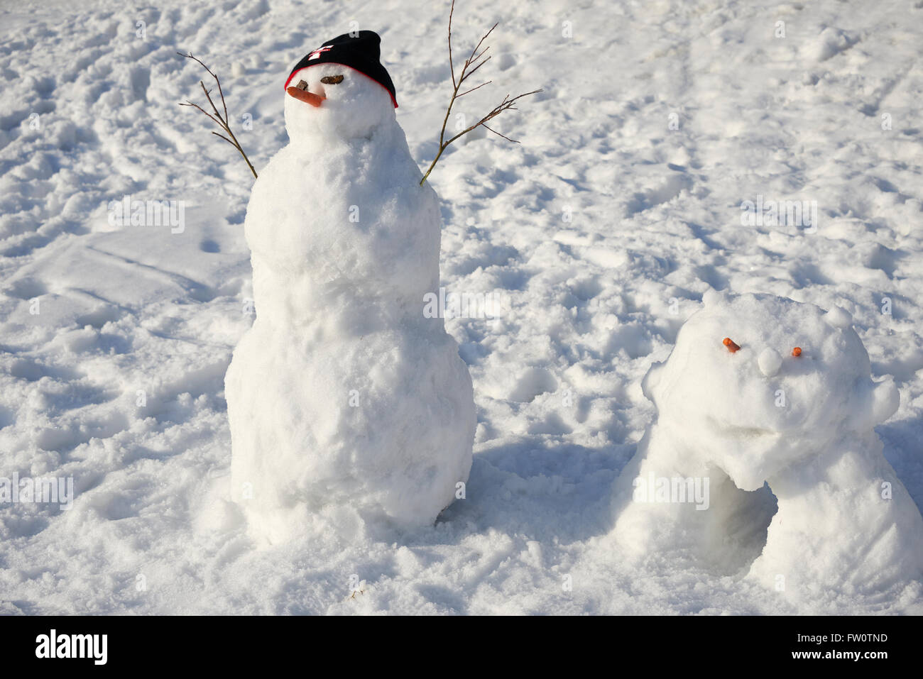 Snowman creature standing in winter landscape, made by children. A ...