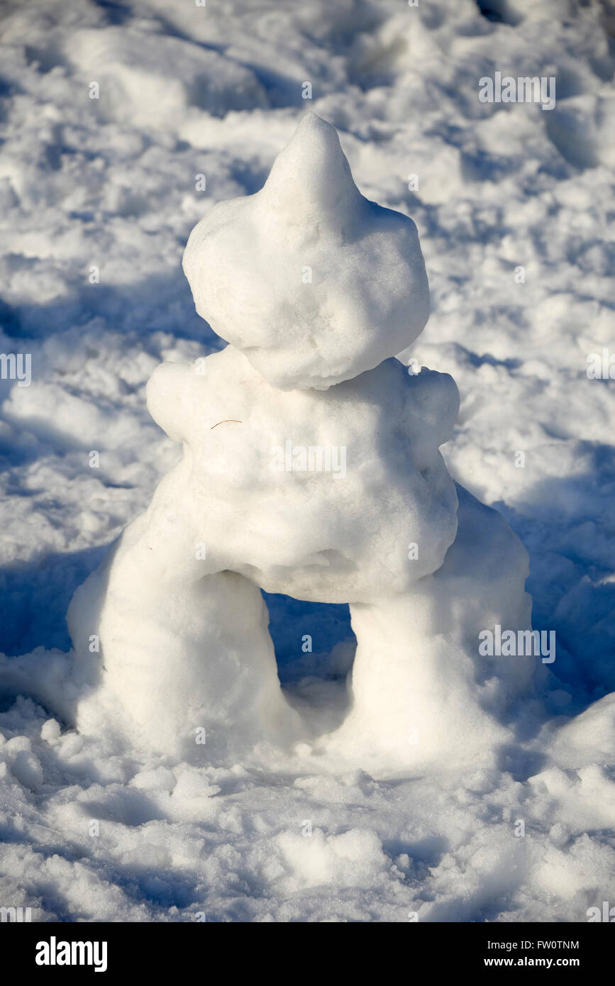 Snowman creature standing in winter landscape, made by children. A ...
