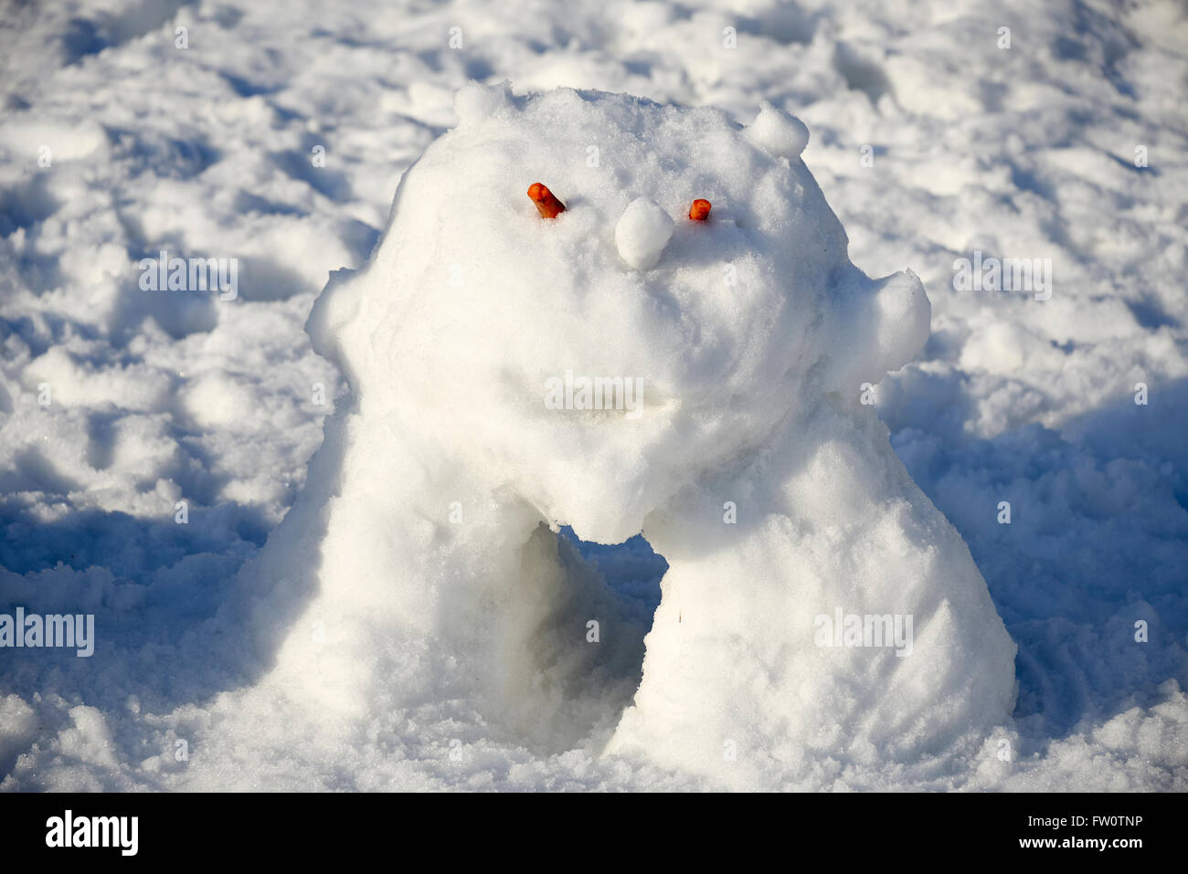 Snowman creature standing in winter landscape, made by children. A ...