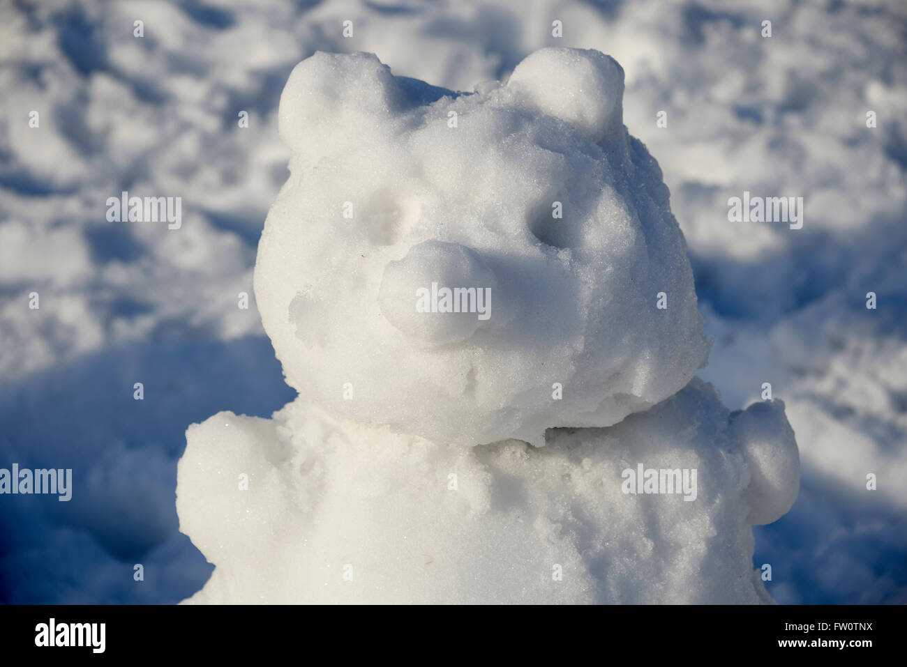 Snowman creature standing in winter landscape, made by children. A ...