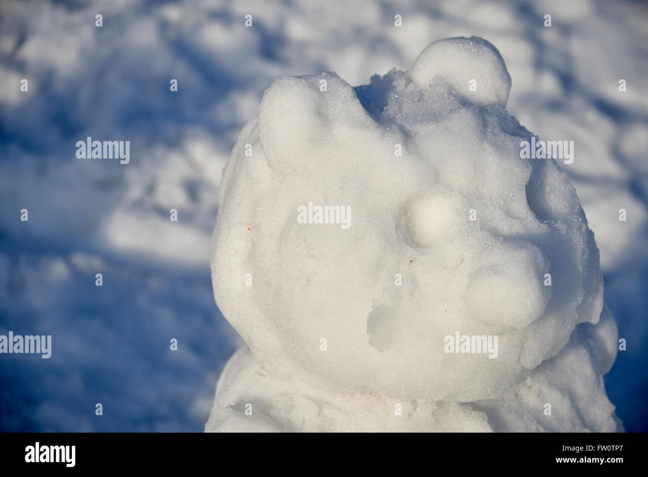 Snowman creature standing in winter landscape, made by children. A ...