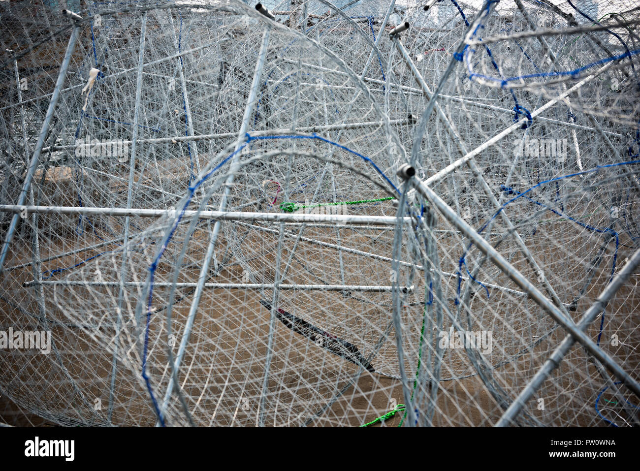 Metal fishing nets in a port. Horizontal shot Stock Photo - Alamy