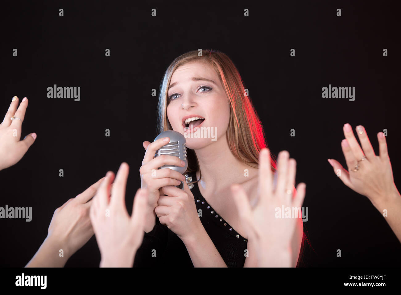 Girl singing at talent show hi-res stock photography and images - Alamy
