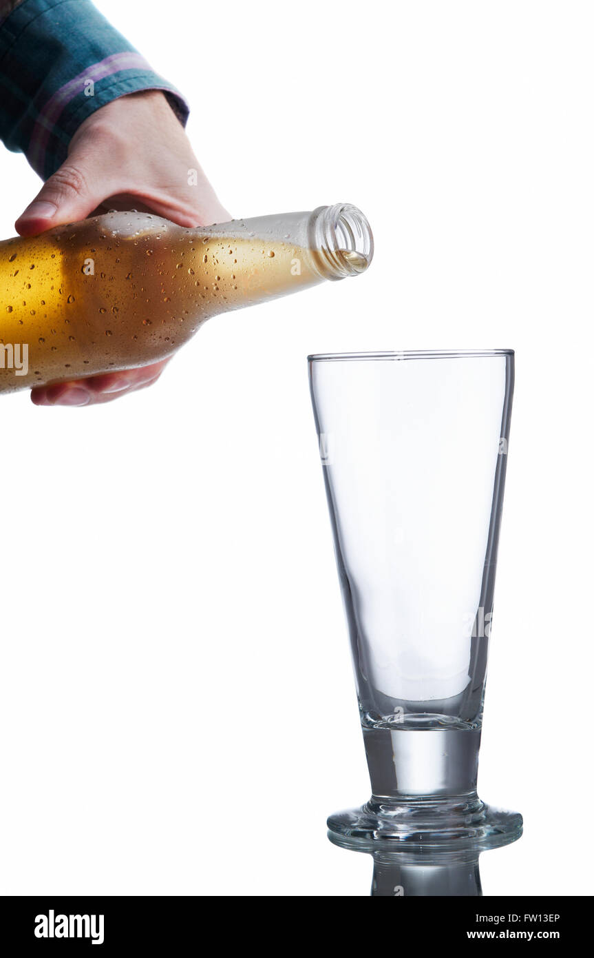 Non-glossy white beer bottle, back lighted showing a glowing golden ...