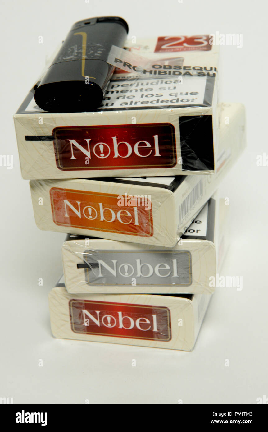 Selection of Nobel Cigarettes packets with lighter on white background ...