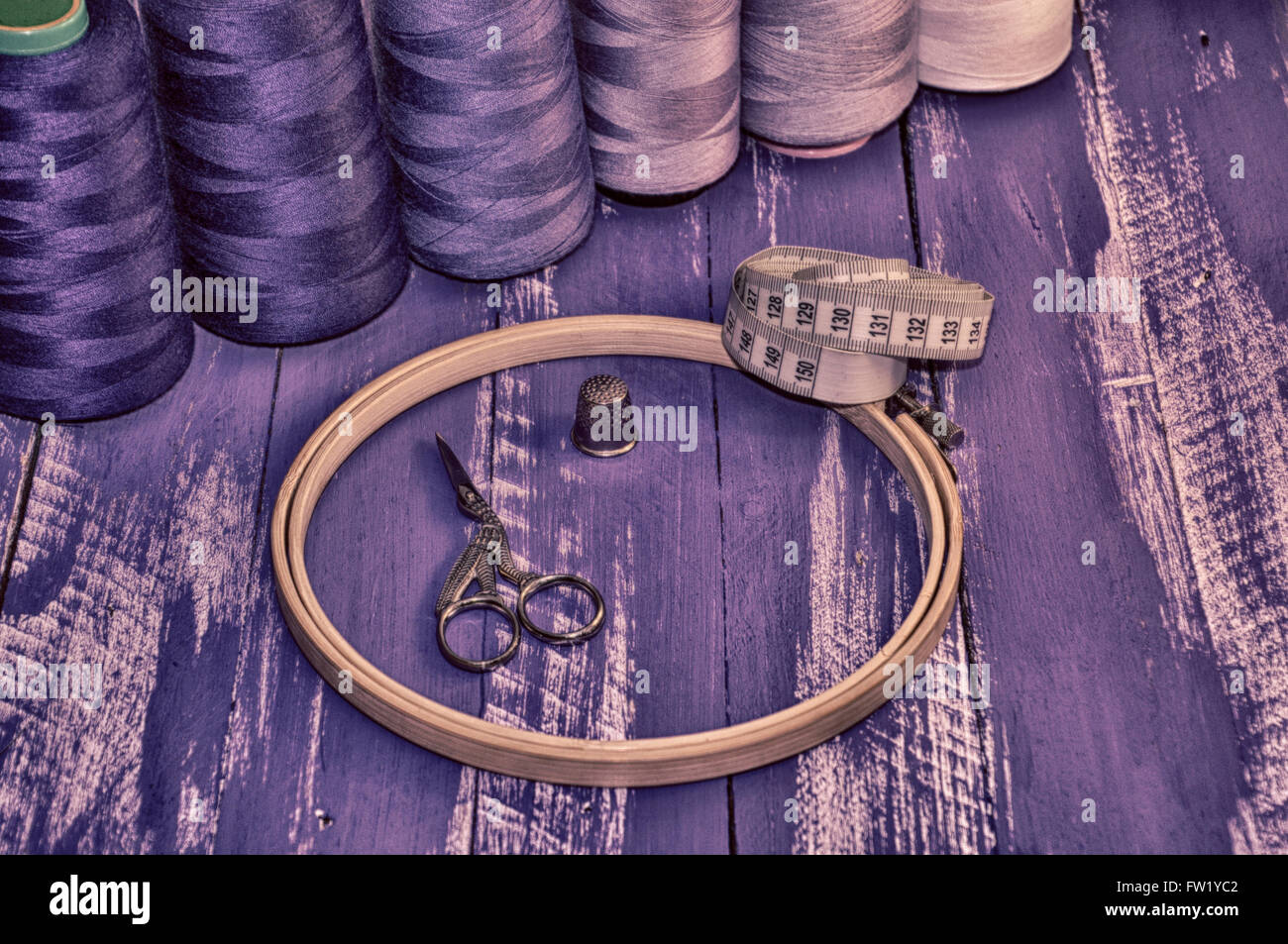 The stylized retro photo in purple colors of objects for needlework ...