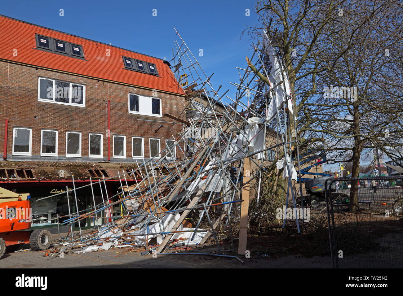 Collapsed scaffolding all bent and twisted laying at an angle where the ...