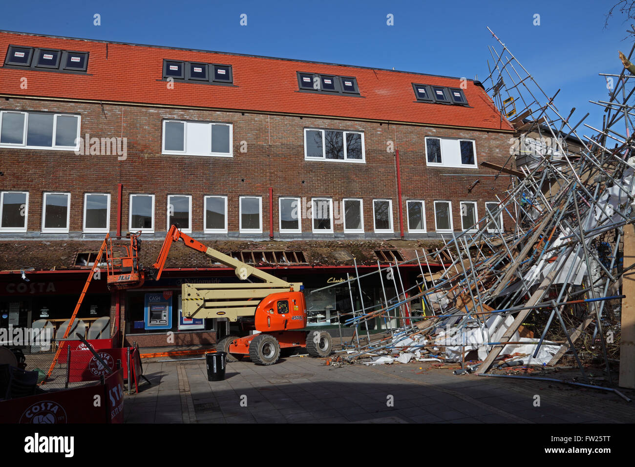 Collapsed scaffolding all bent and twisted laying at an angle where the ...