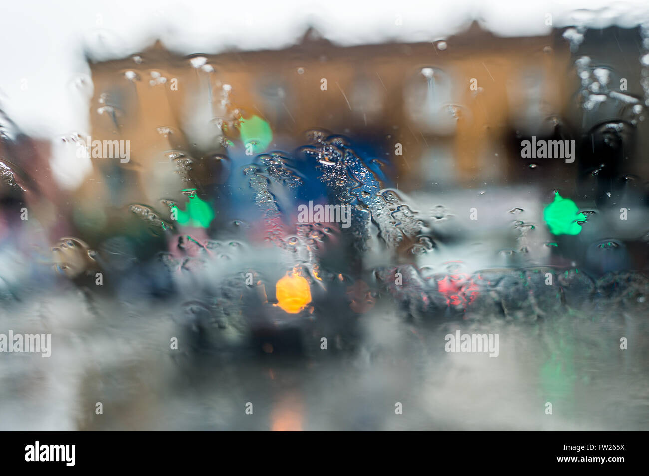 Blurred picture of traffic through a car windscreen during heavy rain ...