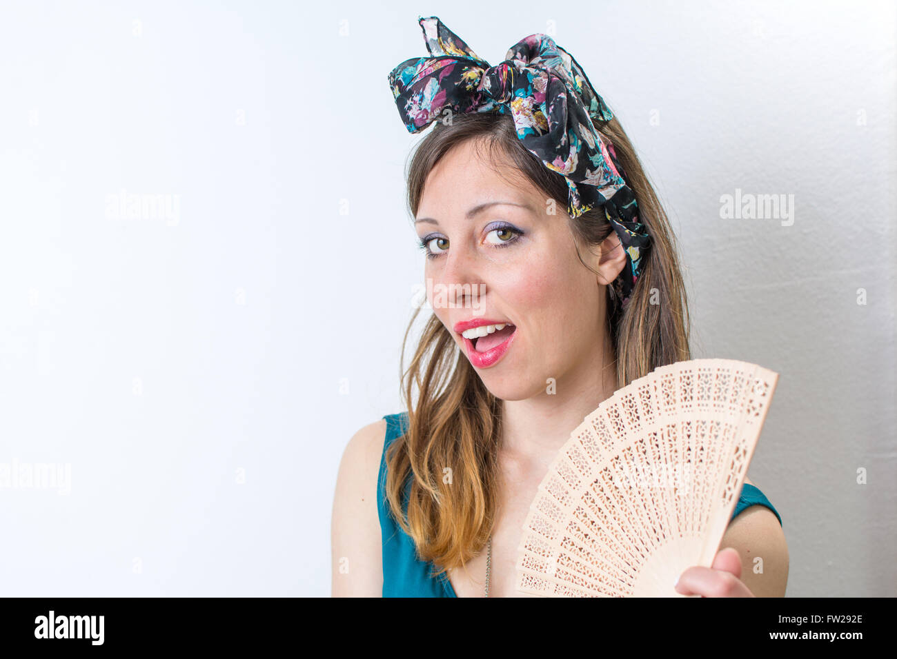 Young woman in bathing suit holding a hand fan Stock Photo - Alamy