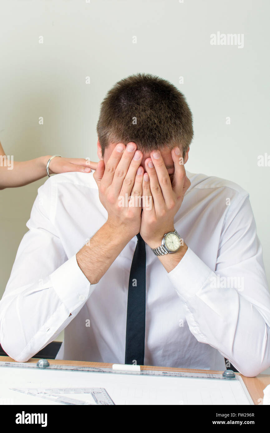 Consoling a young businessman under stress at work Stock Photo - Alamy