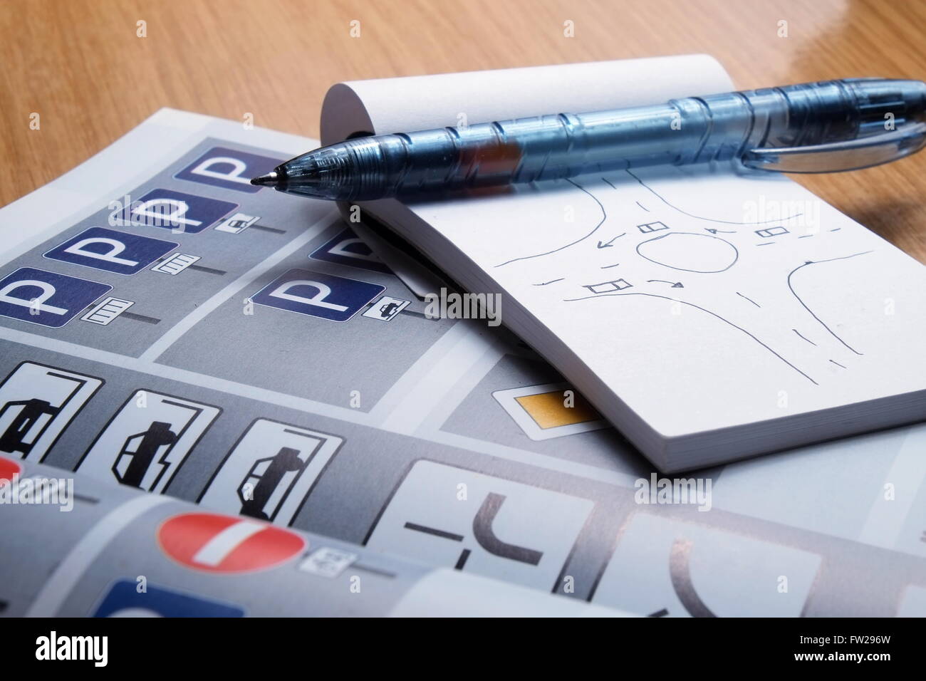 Notepad, book of traffic rules, toy cars, traffic lights and stop sign ...