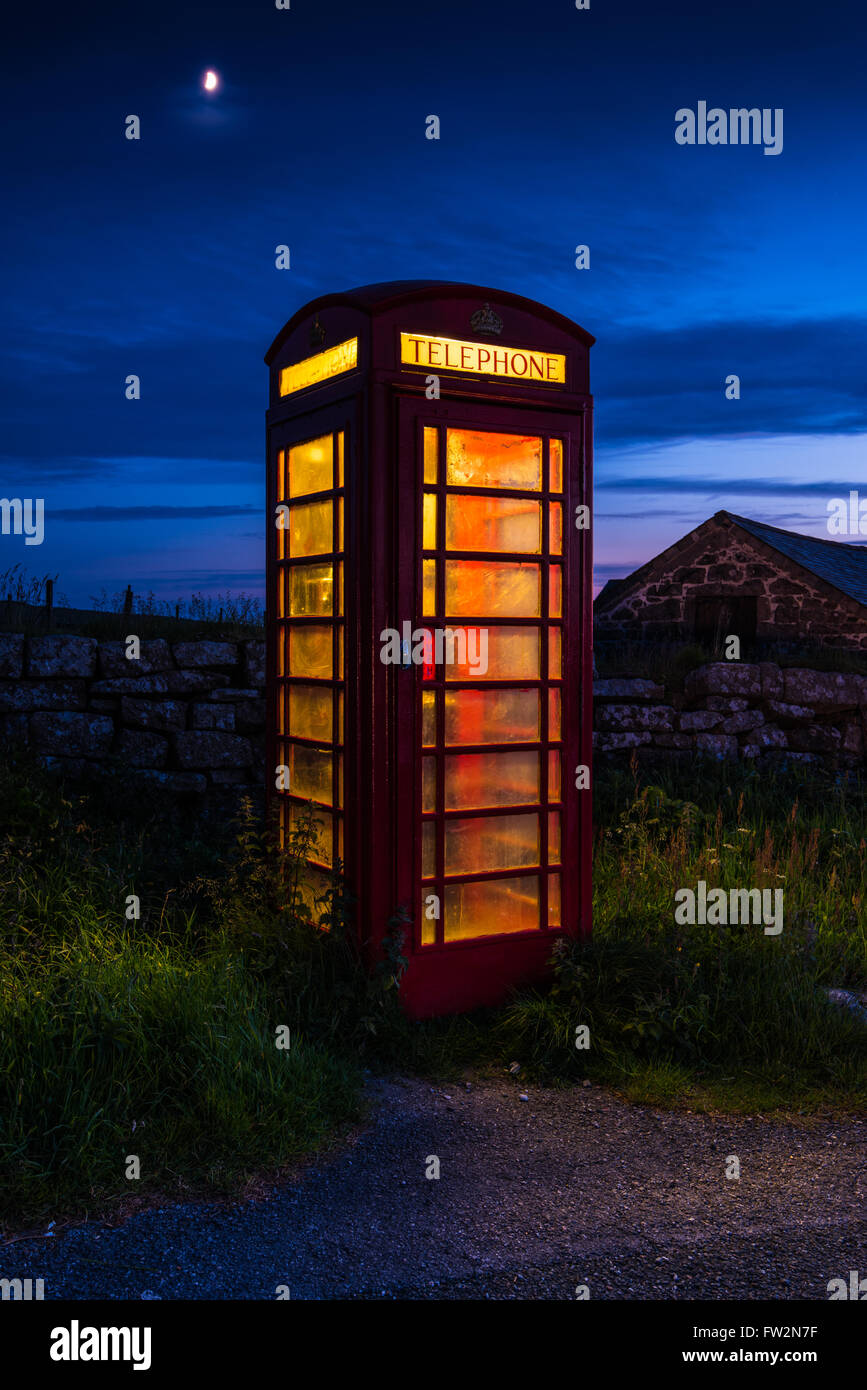 Iconic red phone booth in English countryside at night Stock Photo - Alamy
