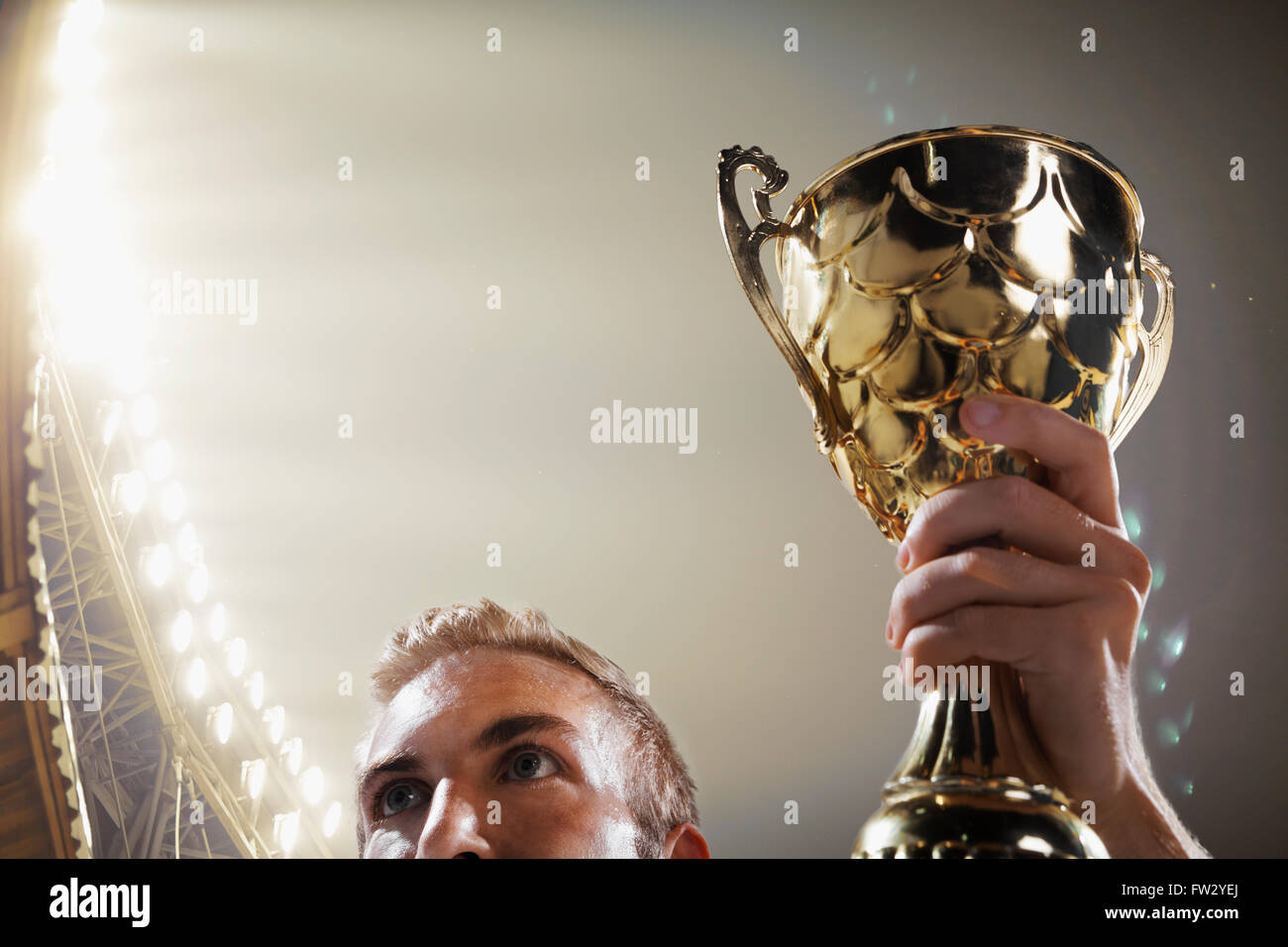 Athlete holding trophy cup Stock Photo - Alamy