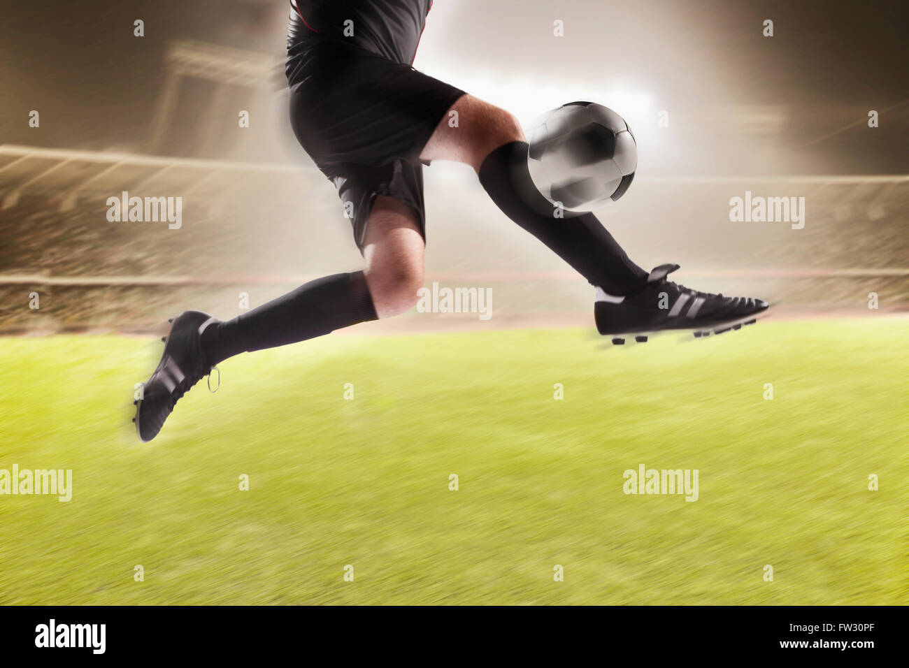 Athlete kicking soccer ball Stock Photo - Alamy