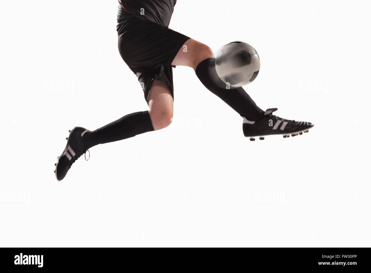 Athlete kicking soccer ball Stock Photo - Alamy