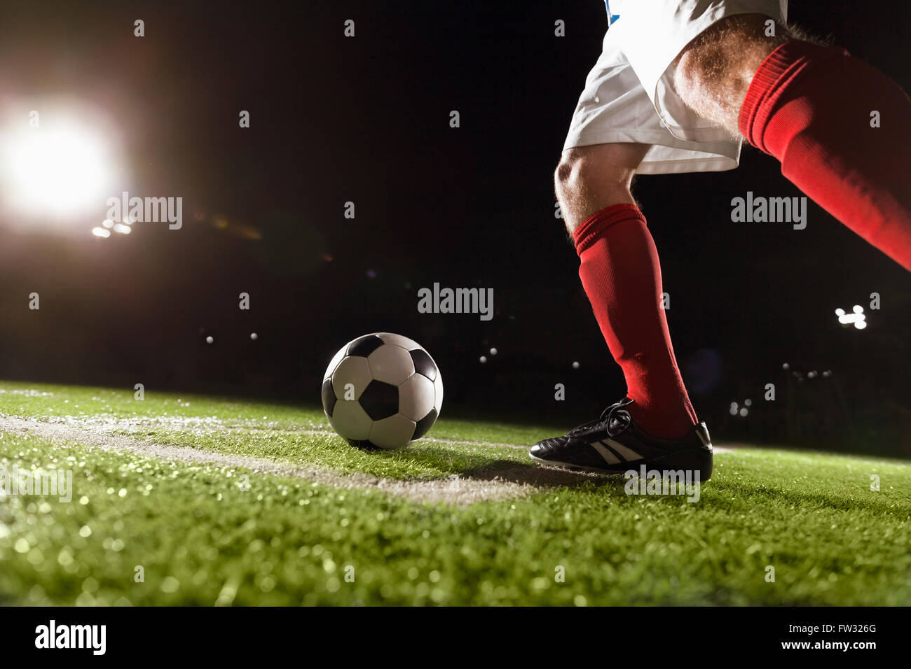 Soccer player making a corner kick Stock Photo - Alamy