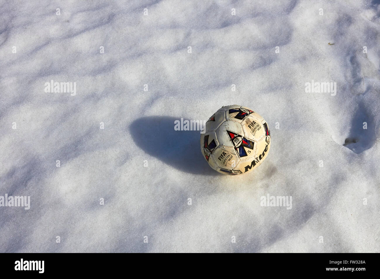 worn-out football on snow Stock Photo - Alamy
