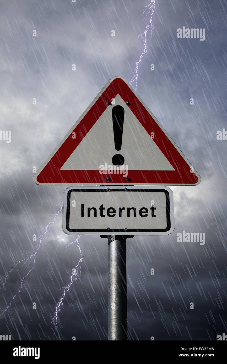 Warning and Internet road signs againt a rainy sky with lightning Stock ...