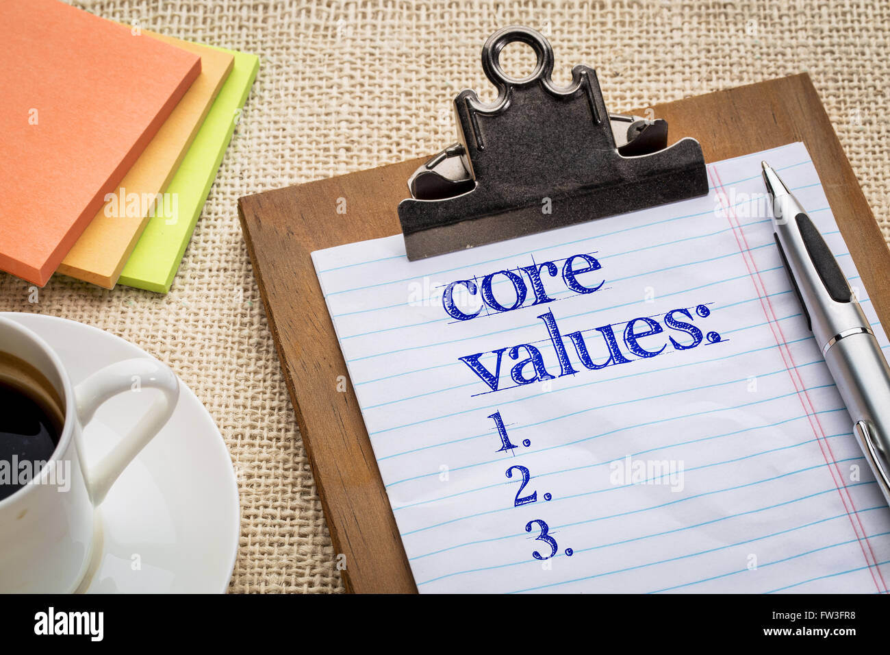 core values list on clipboard with a pen, coffee and sticky notes ...