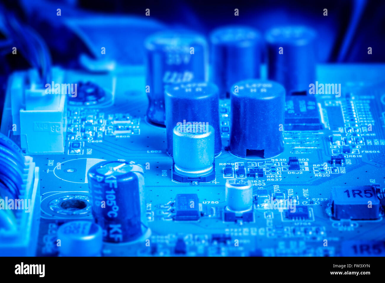 Power capacitors and chips in blue color on a microcircuit board Stock ...