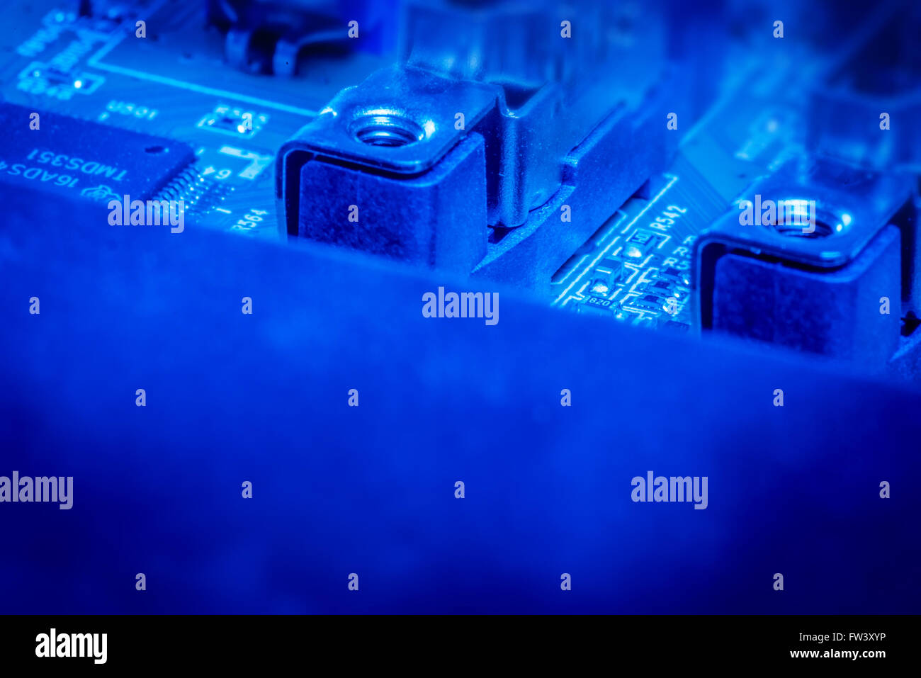 Microcircuit board in blue color with capacitors and chips Stock Photo ...