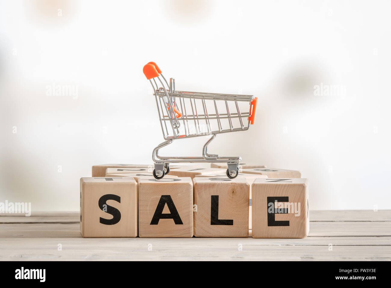 Sale sign with a metallic shopping cart Stock Photo - Alamy
