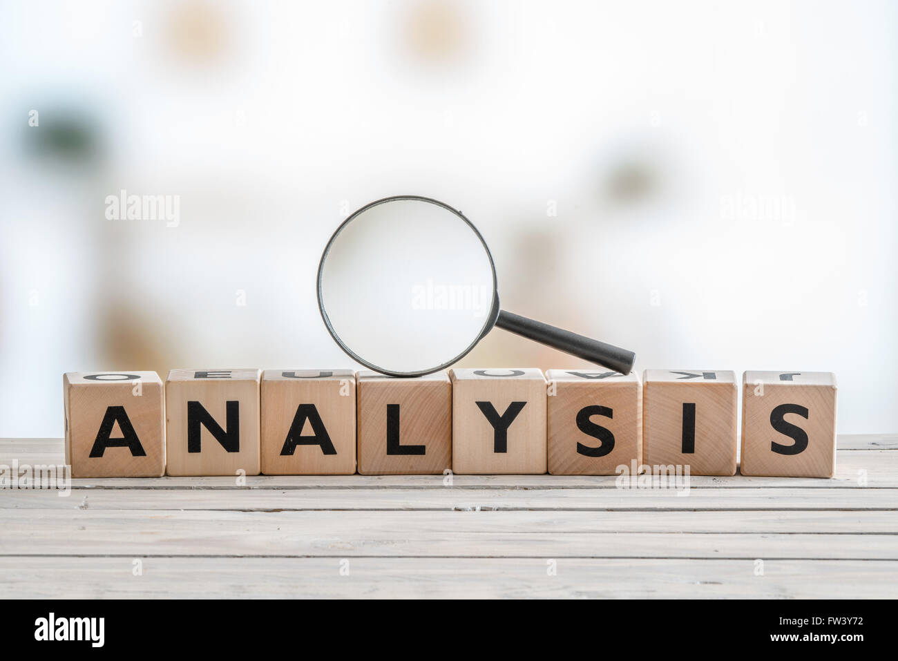 Analysis with a magnifying glass on wooden cubes Stock Photo - Alamy