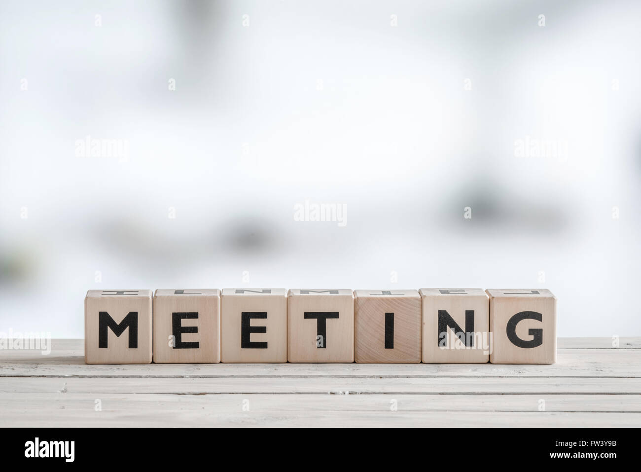 Meeting sign with wooden blocks on an office desk Stock Photo - Alamy