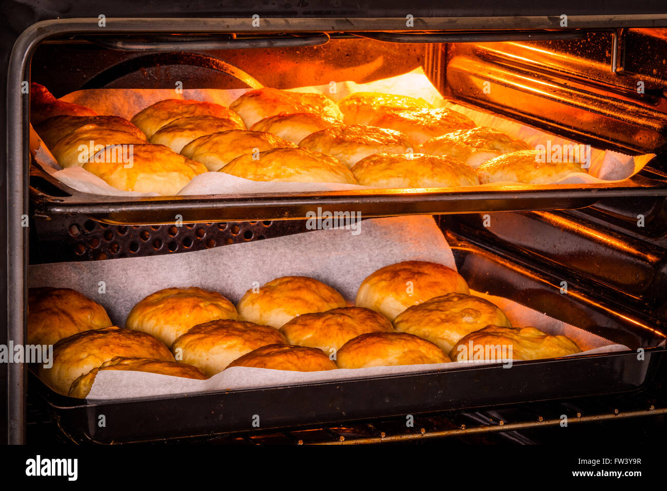 Hot oven with golden buns at a bakery Stock Photo - Alamy
