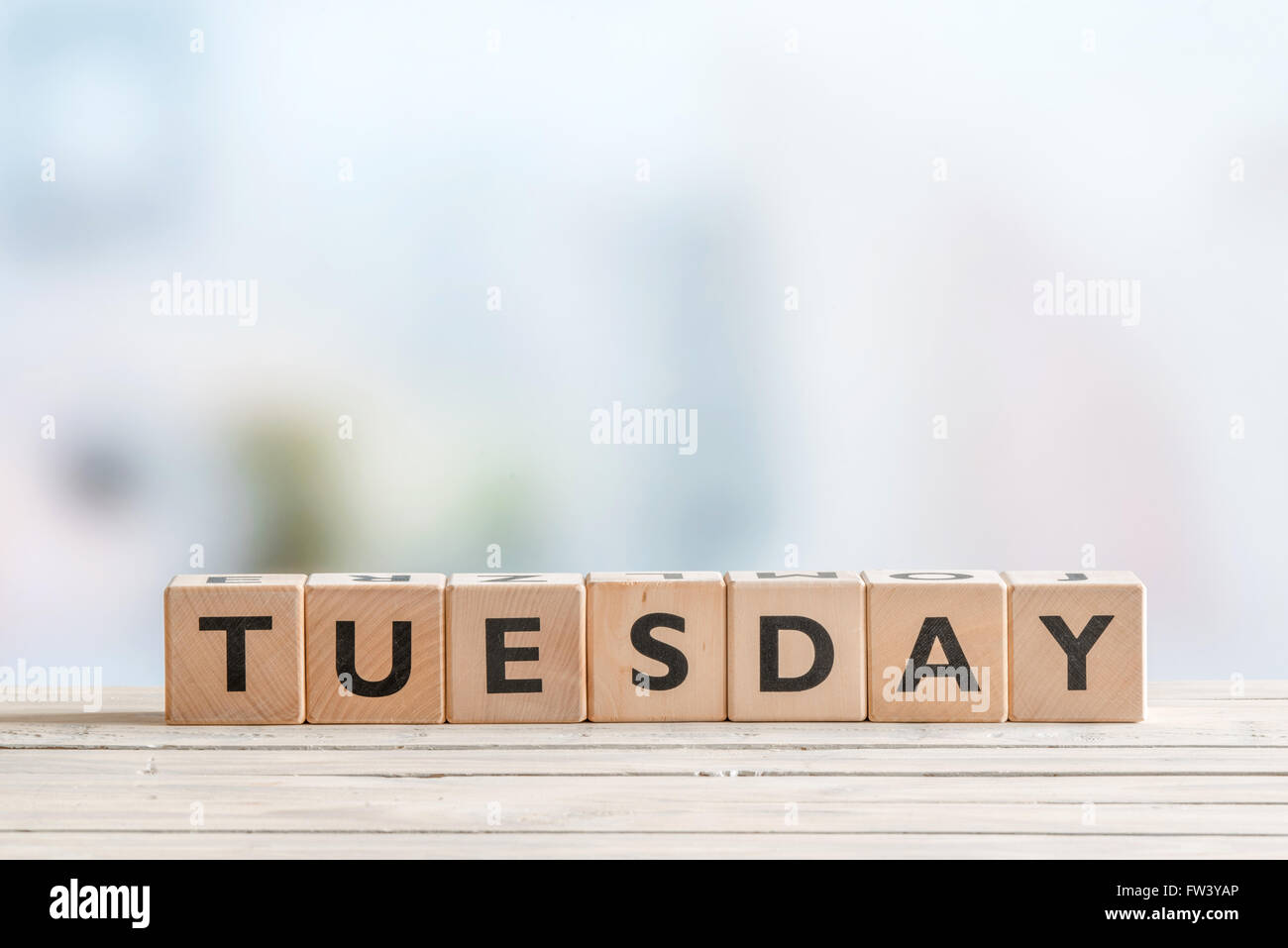 Tuesday sign on a wooden table in bright colors Stock Photo - Alamy