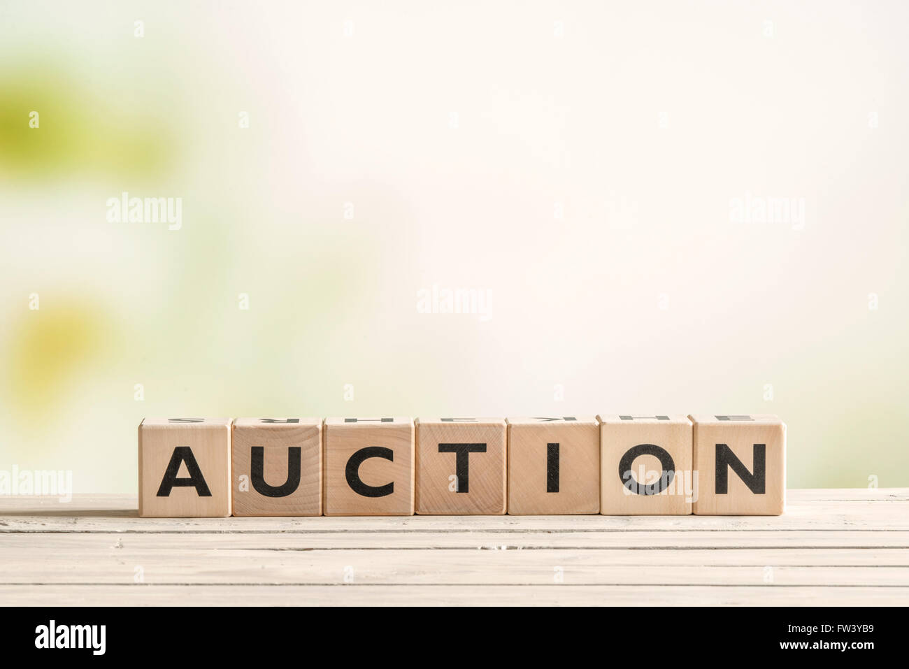 Auction sign on a vintage table on green background Stock Photo - Alamy
